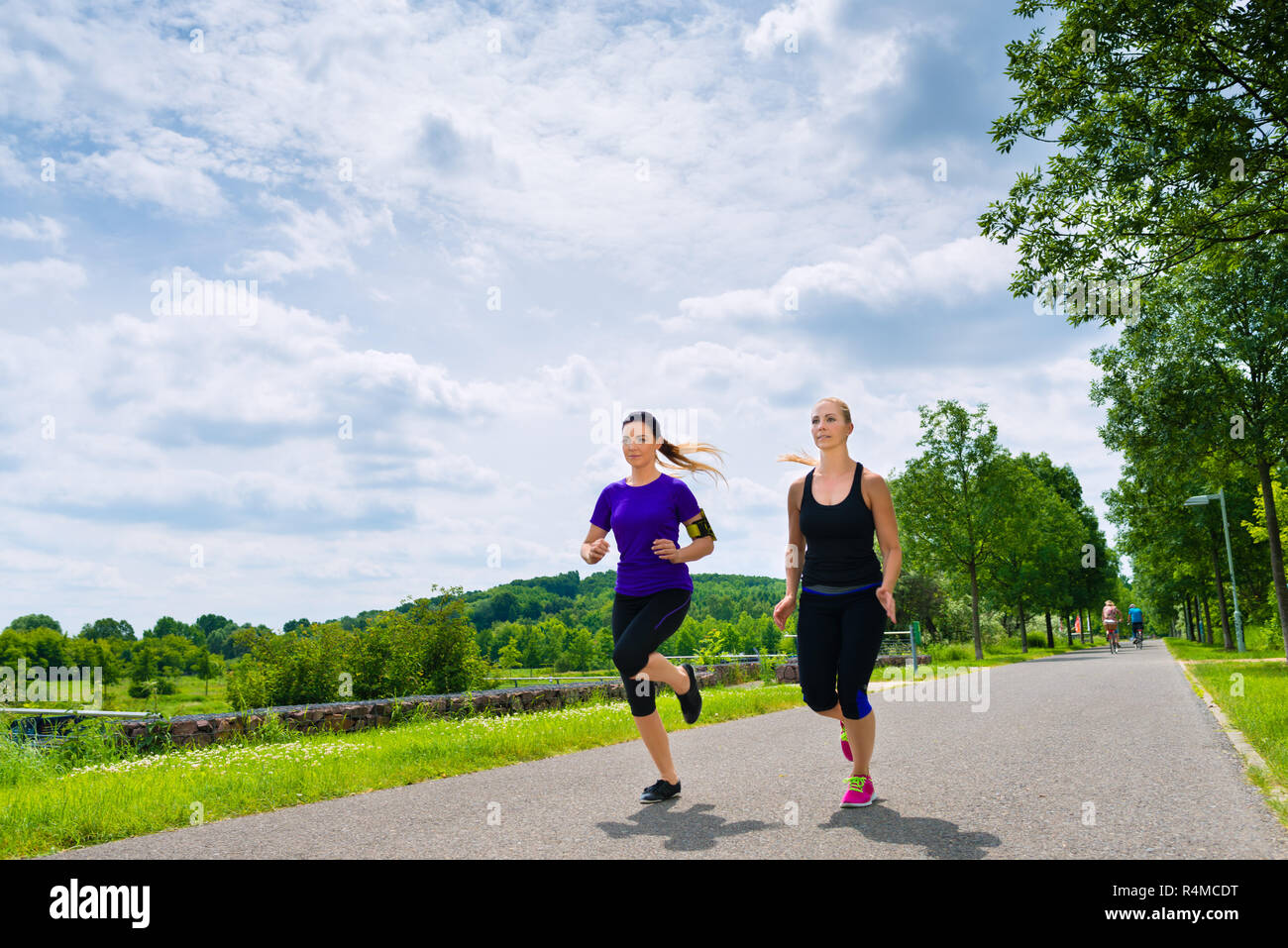 Sports outdoor - young women running in park Stock Photo - Alamy