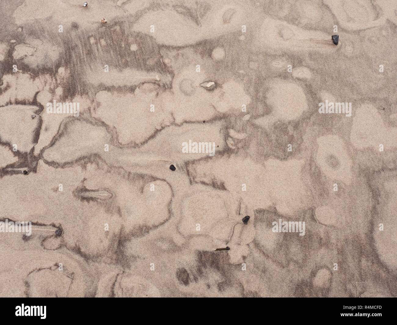 Sediments in wet sand created natural kind of picture. Swirls with a ...