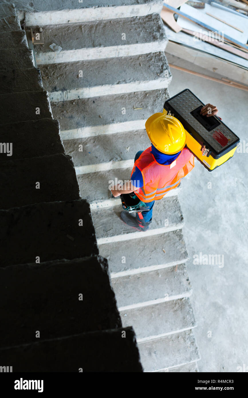 Builder or craftsman carrying a toolbox construction site Stock Photo ...