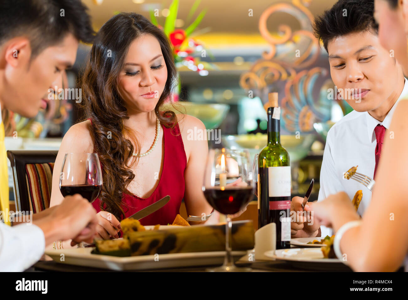 Chinese couples toasting with wine in restaurant Stock Photo - Alamy