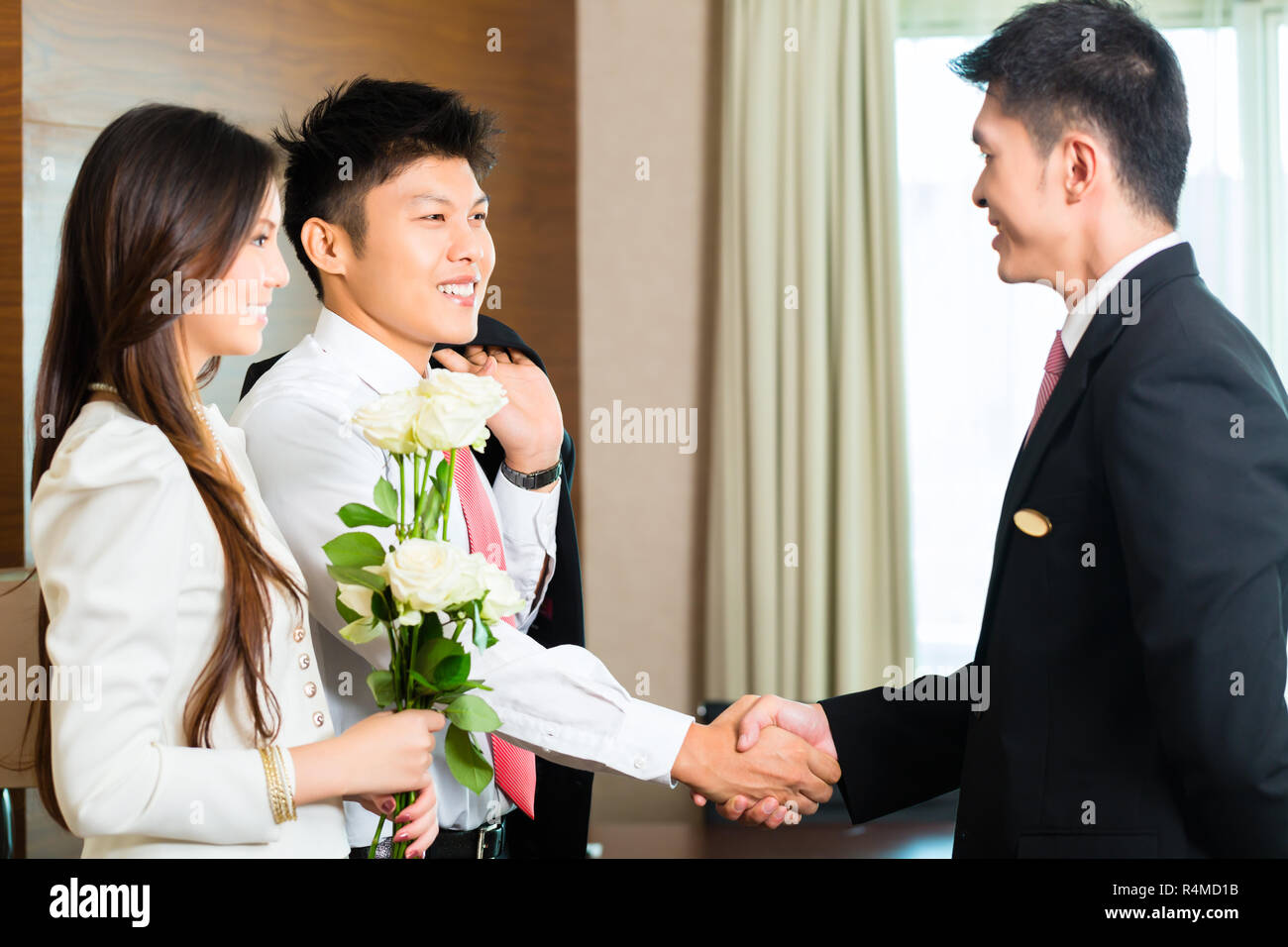 Hotel worker welcoming guests hi-res stock photography and images - Alamy