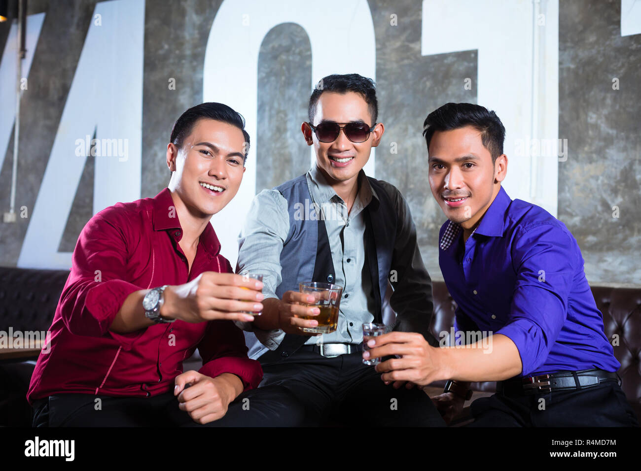 Asian friends drinking shots in nightclub Stock Photo - Alamy