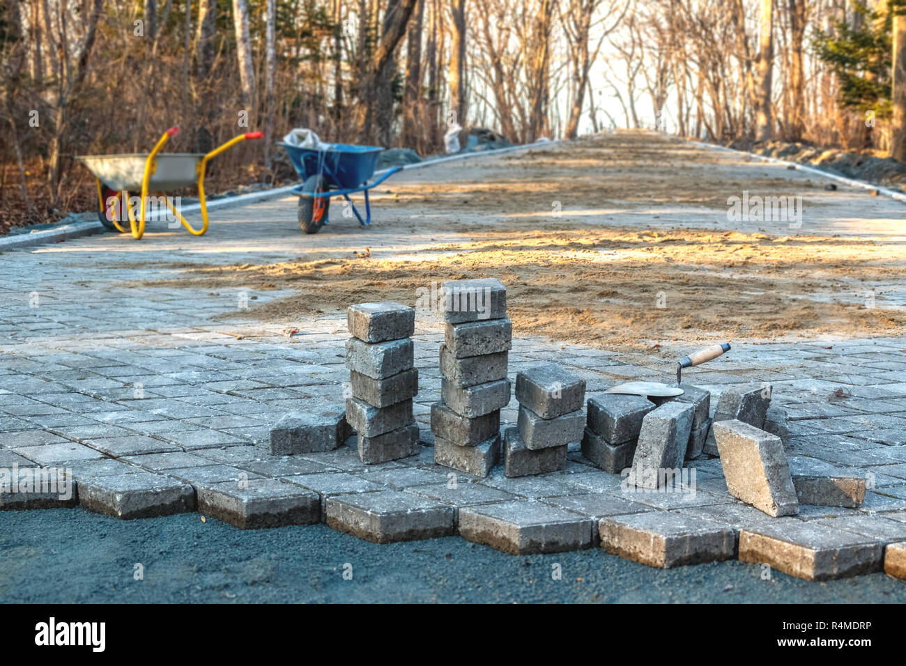 Construction site and paving on a walking path in a public park. Scene ...