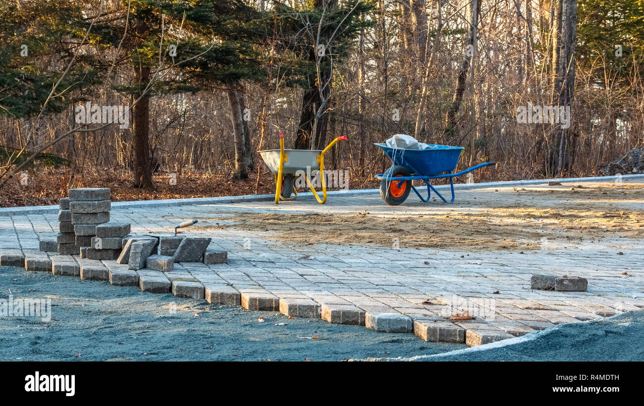 Construction site and paving on a walking path in a public park. Scene ...