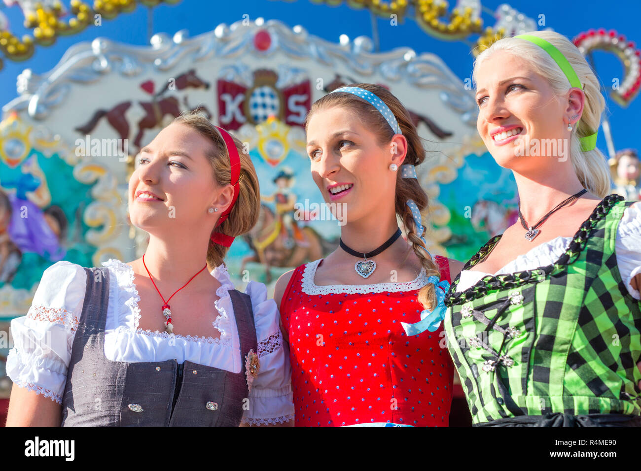 Friends visiting Bavarian fair having fun Stock Photo - Alamy