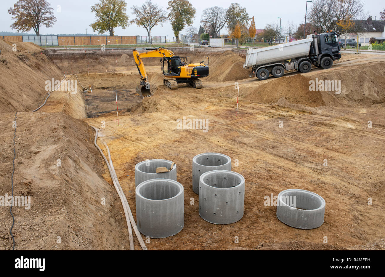 digger and truck working in excavation pit Stock Photo - Alamy