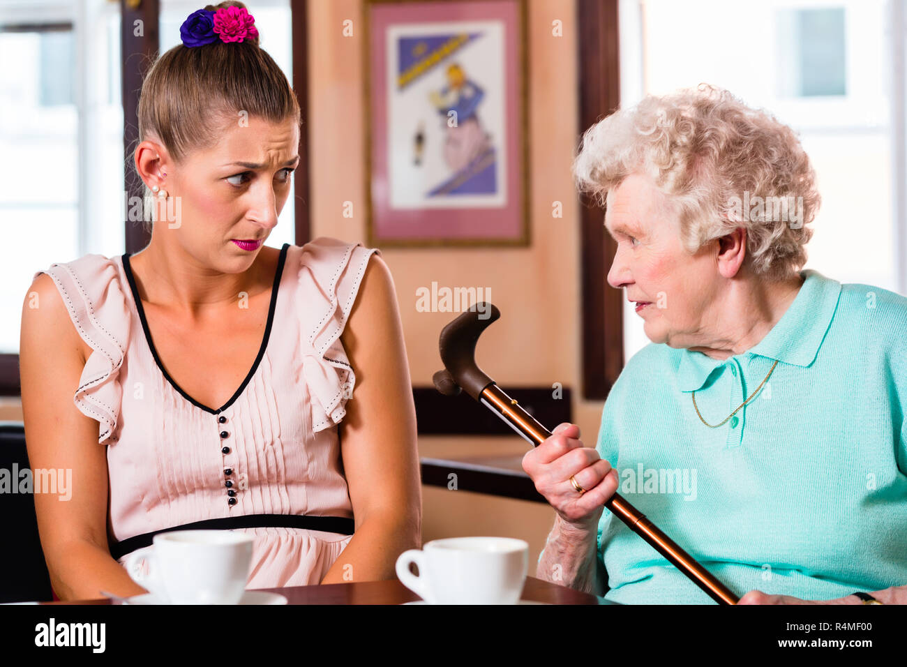 Granny and granddaughter at argument in cafe Stock Photo - Alamy