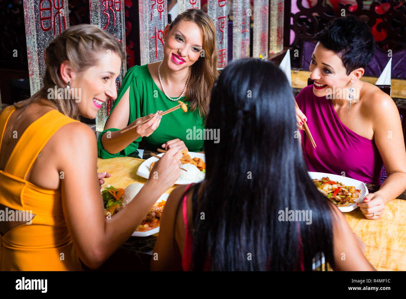 Young people eating in Asia restaurant Stock Photo - Alamy