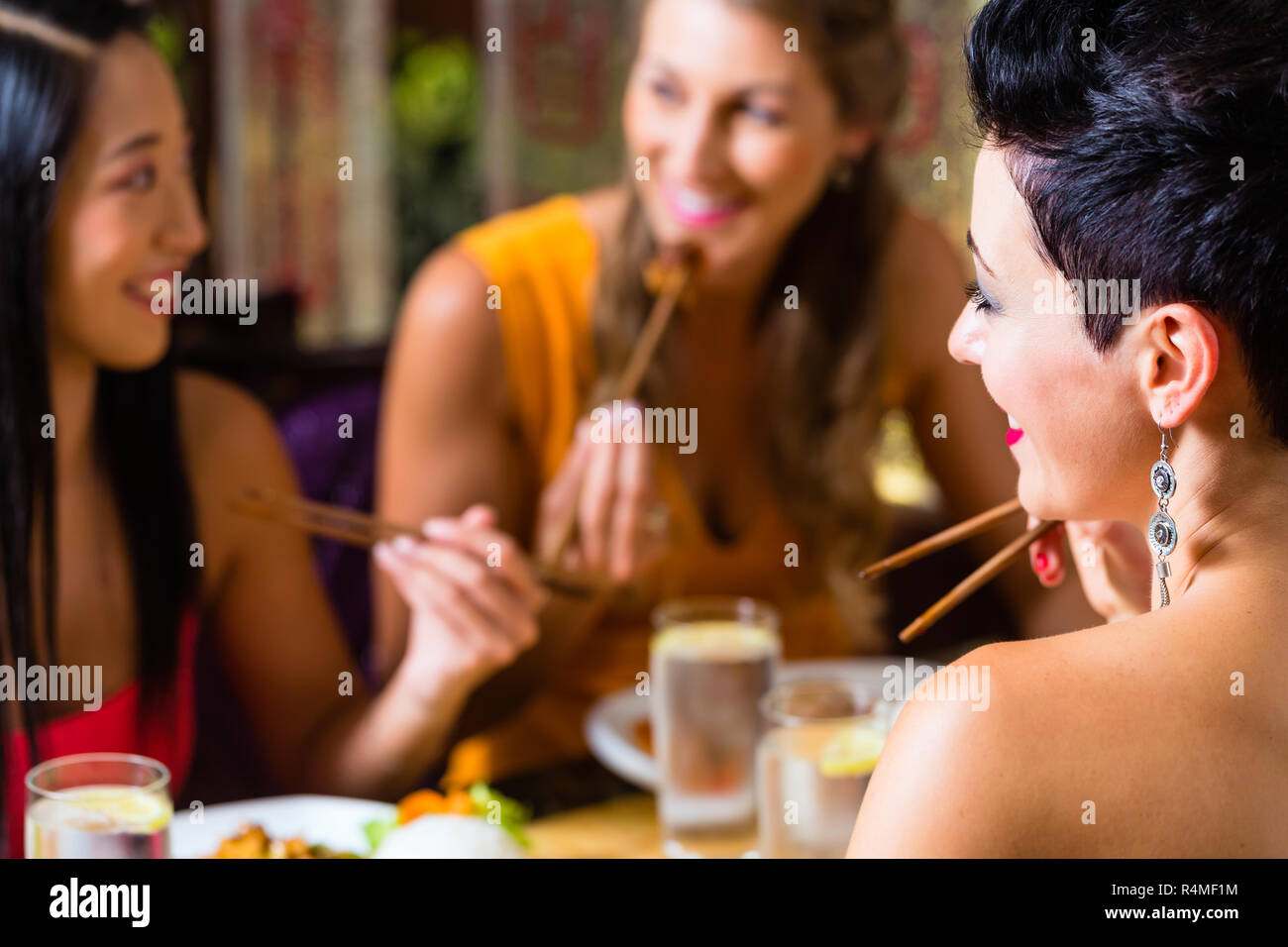 Young people eating in Asia restaurant Stock Photo - Alamy