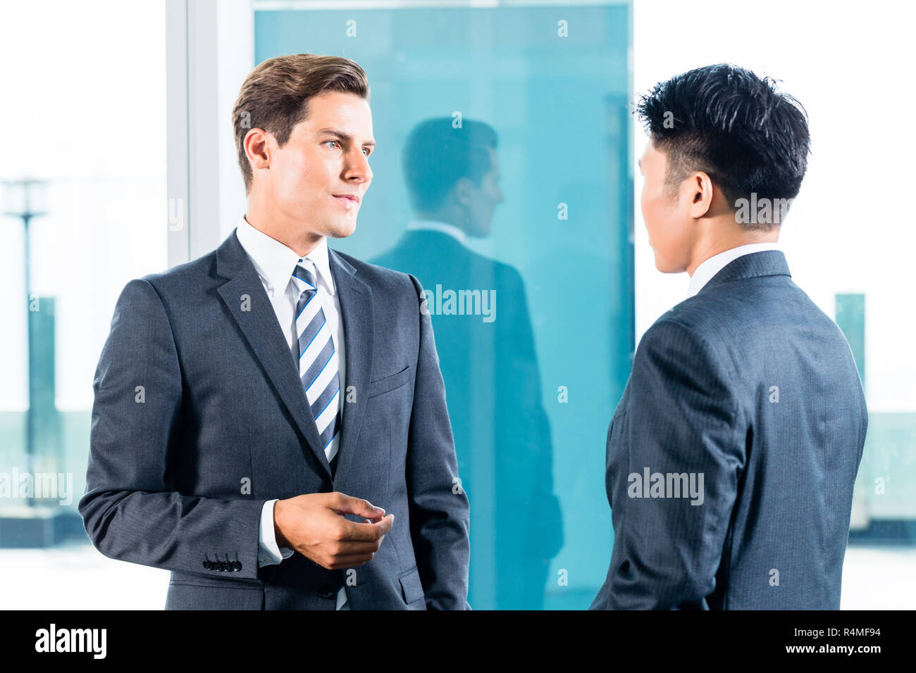 Business men talking in office discussing Stock Photo - Alamy