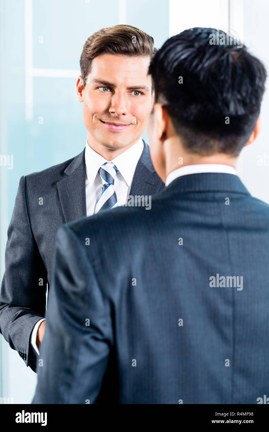 Business men talking in office discussing Stock Photo - Alamy