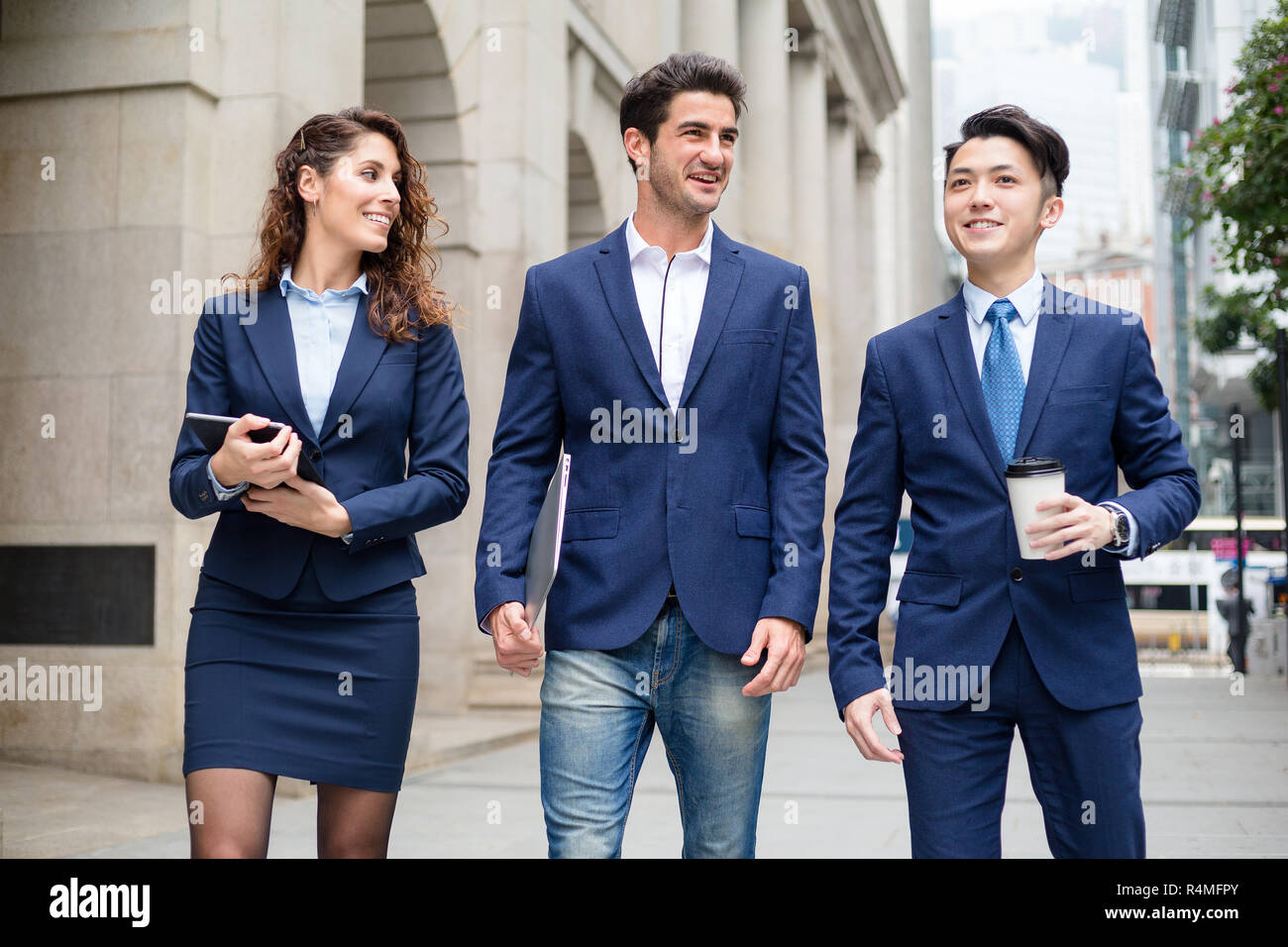 Business team walking outside office Stock Photo - Alamy