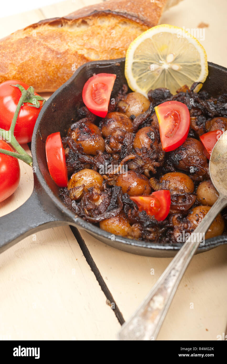Baby cuttle fish roasted on iron skillet Stock Photo - Alamy