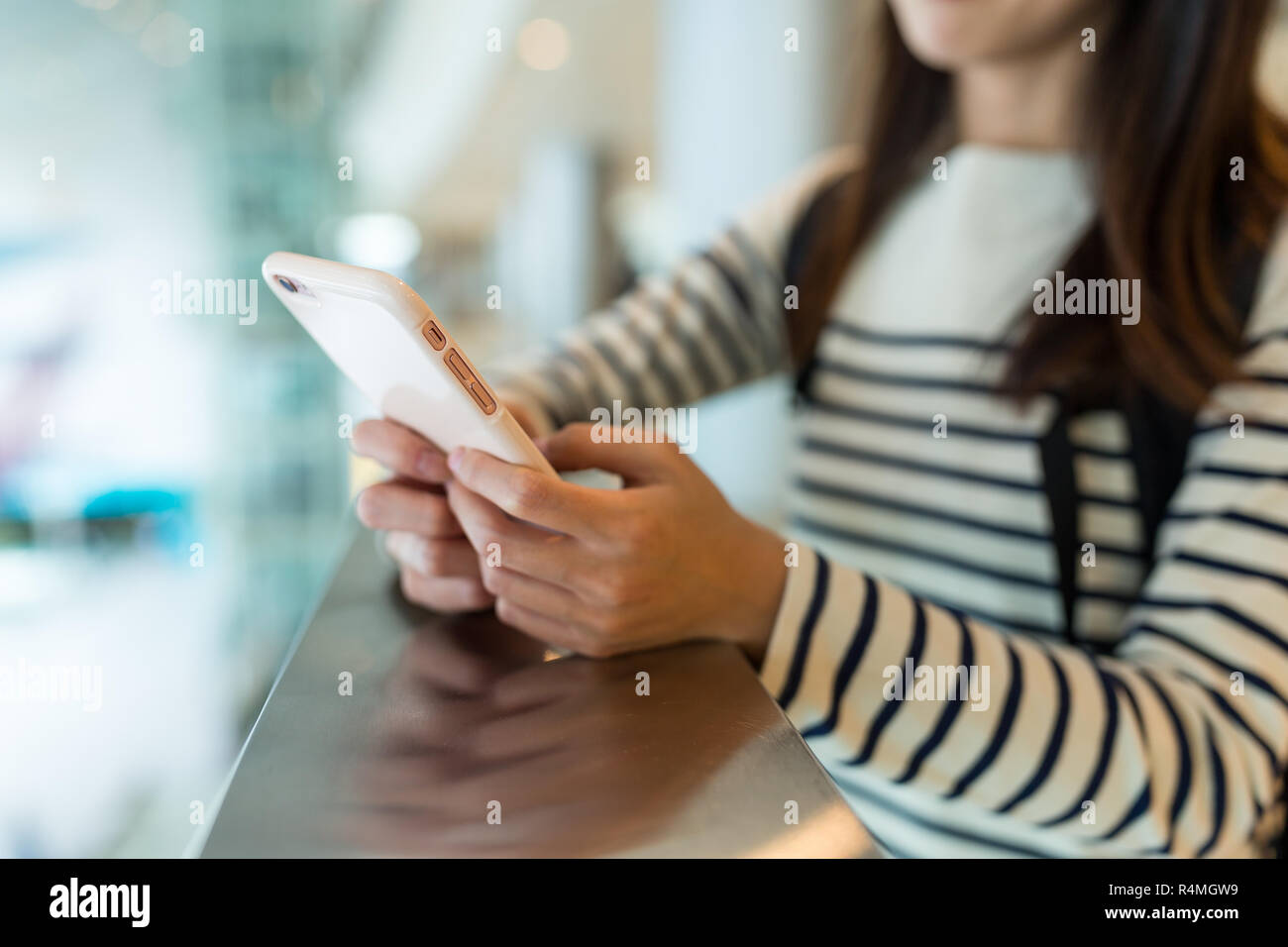 Woman use of mobile phone in shopping mall Stock Photo - Alamy