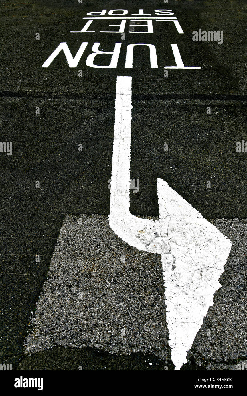 Stop and turn left white painted road marker sign Stock Photo - Alamy