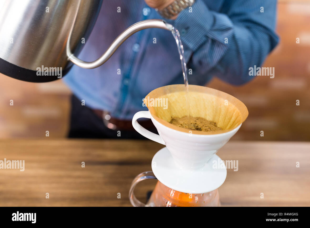 Barista Pouring water on coffee filter Stock Photo - Alamy