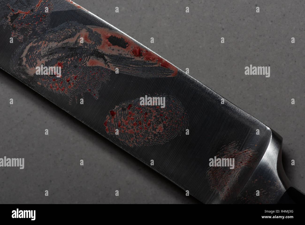 Dusted finger prints showing up as forensic eveidence on a sharp steel ...