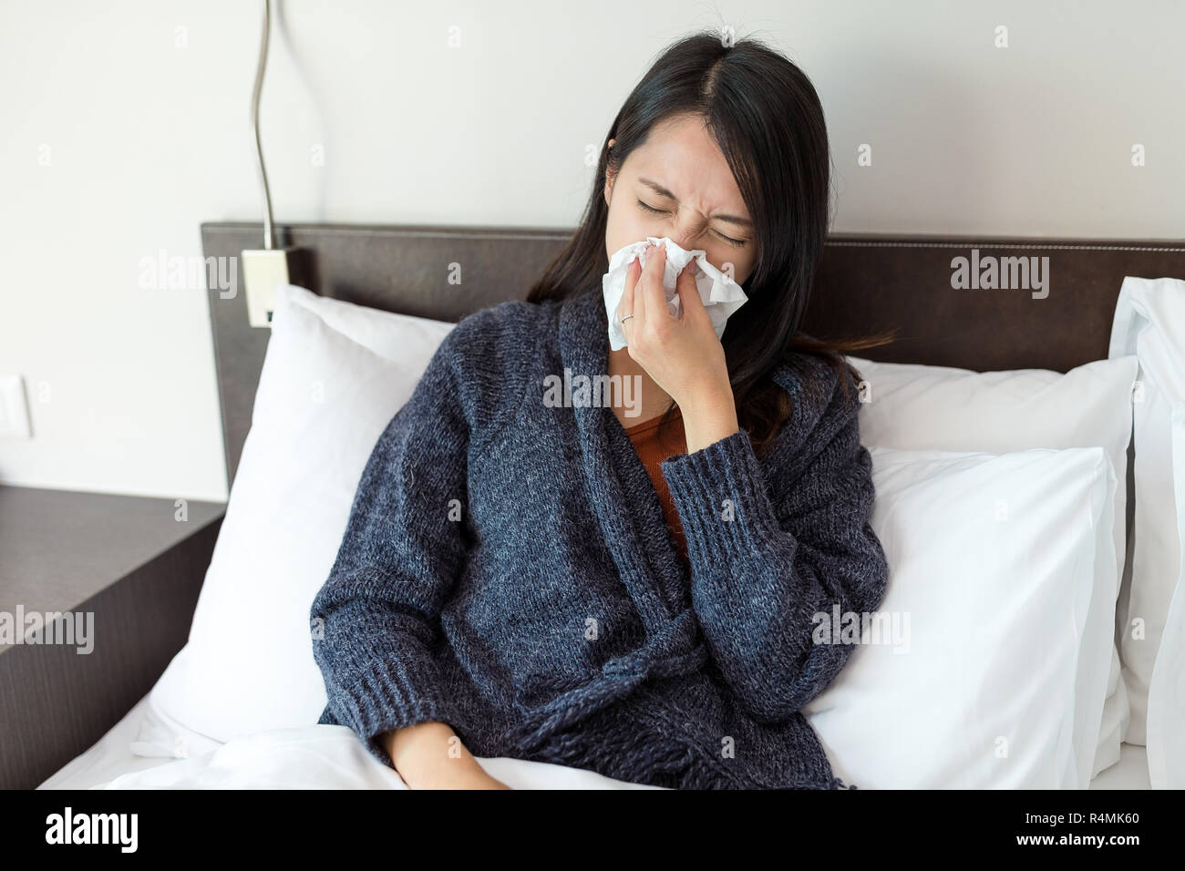 Woman feeling sick and lying on bed Stock Photo - Alamy