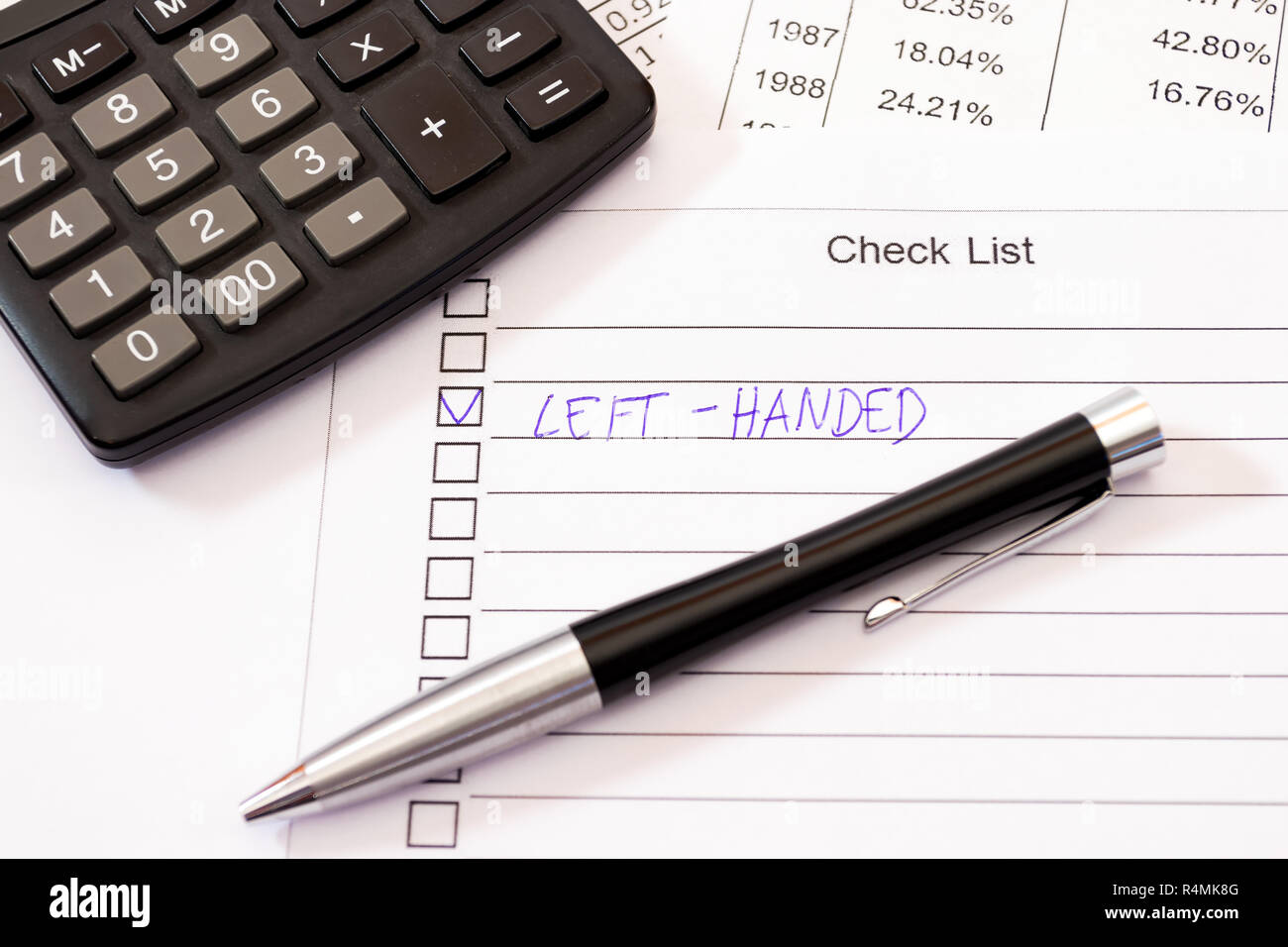 Left-handed ticked position on a check list with elegant pen ...