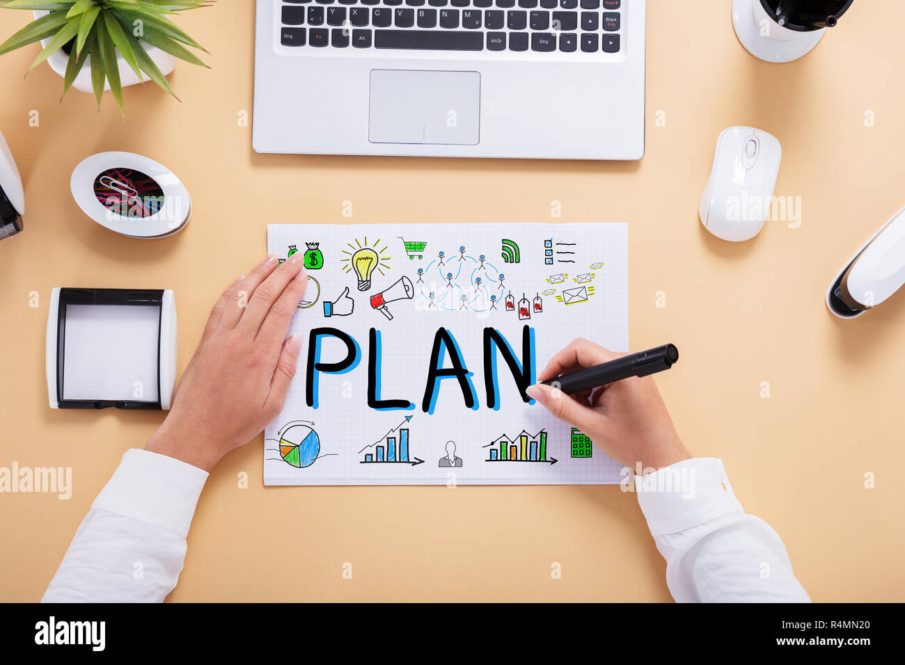Businessperson Drawing Plan Chart On Office Desk Stock Photo - Alamy