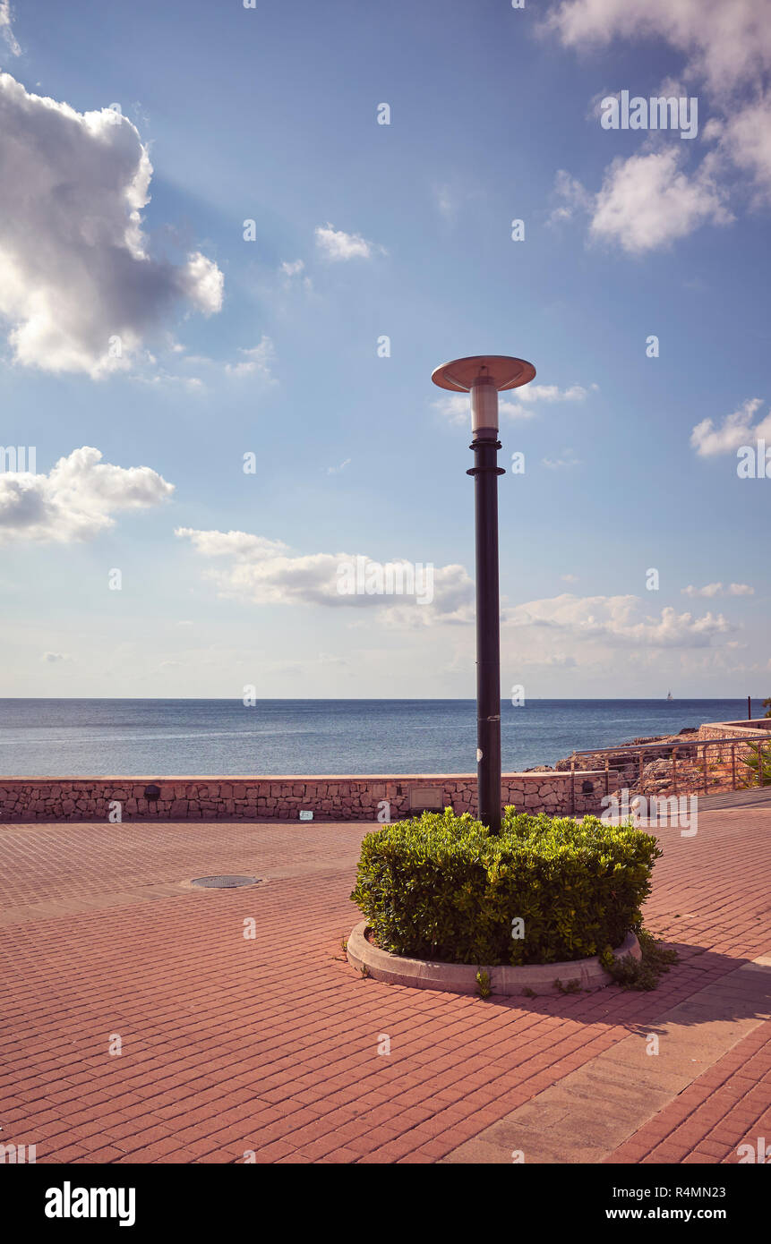 Lamp on an empty promenade, color toned picture Stock Photo - Alamy