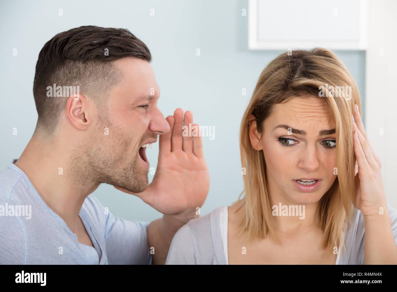 Man Screaming In His Wife's Ear Stock Photo - Alamy