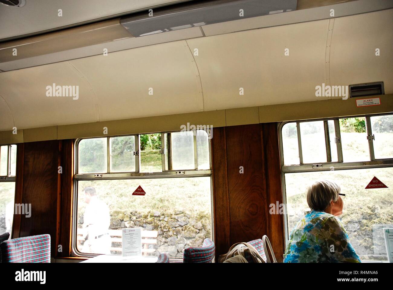 A female passenger looks out of the window of a railway carriage on the ...