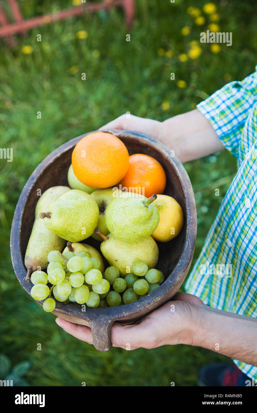Fresh fruit in hands Stock Photo - Alamy