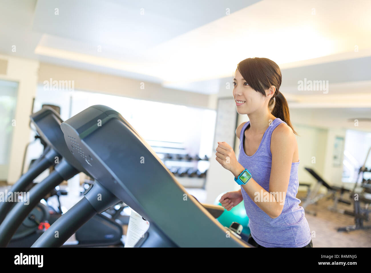 Woman training on treadmill in gym Stock Photo - Alamy