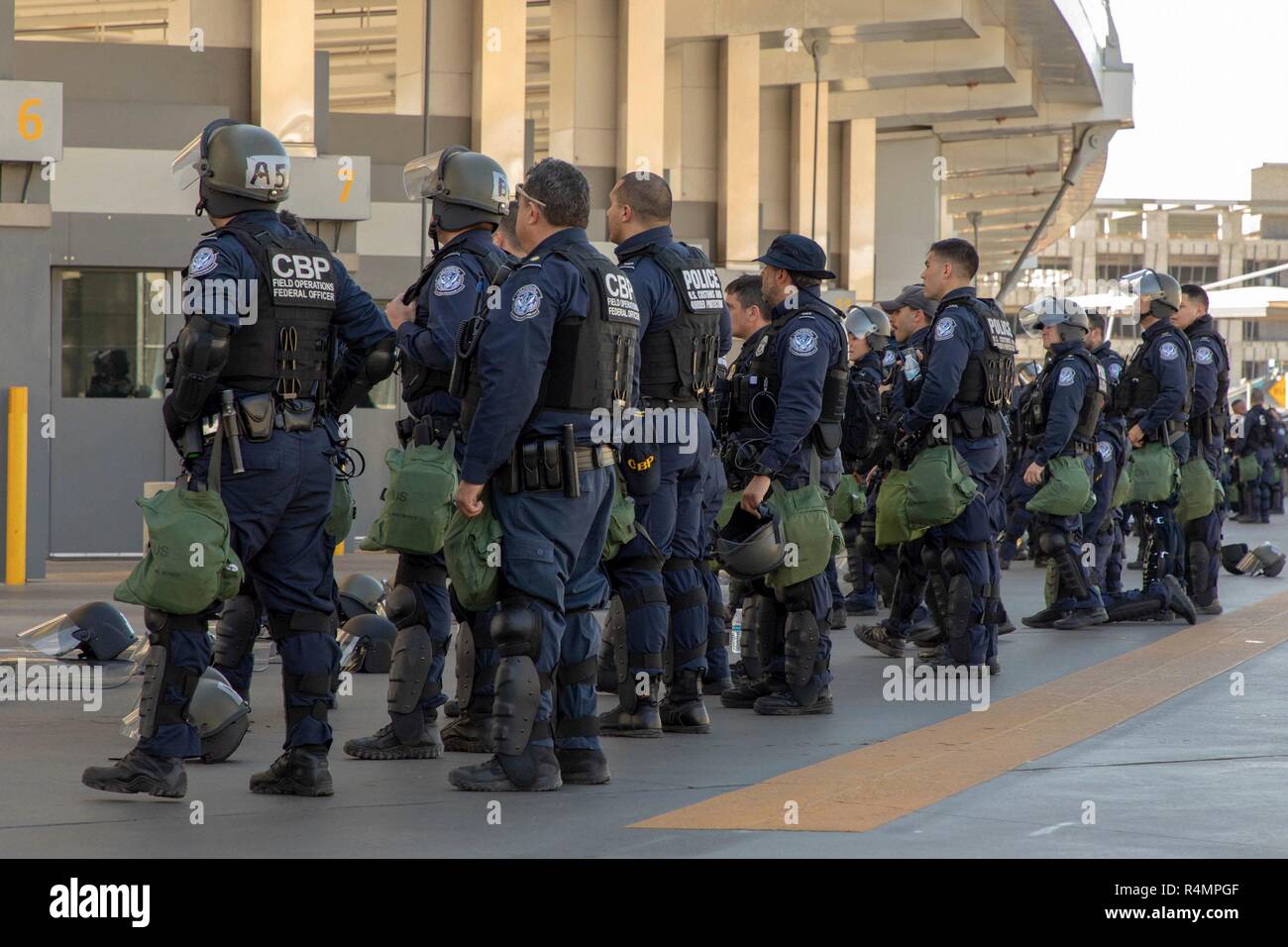 U.S. Customs and Border Patrol agents in riot gear shut the border into ...
