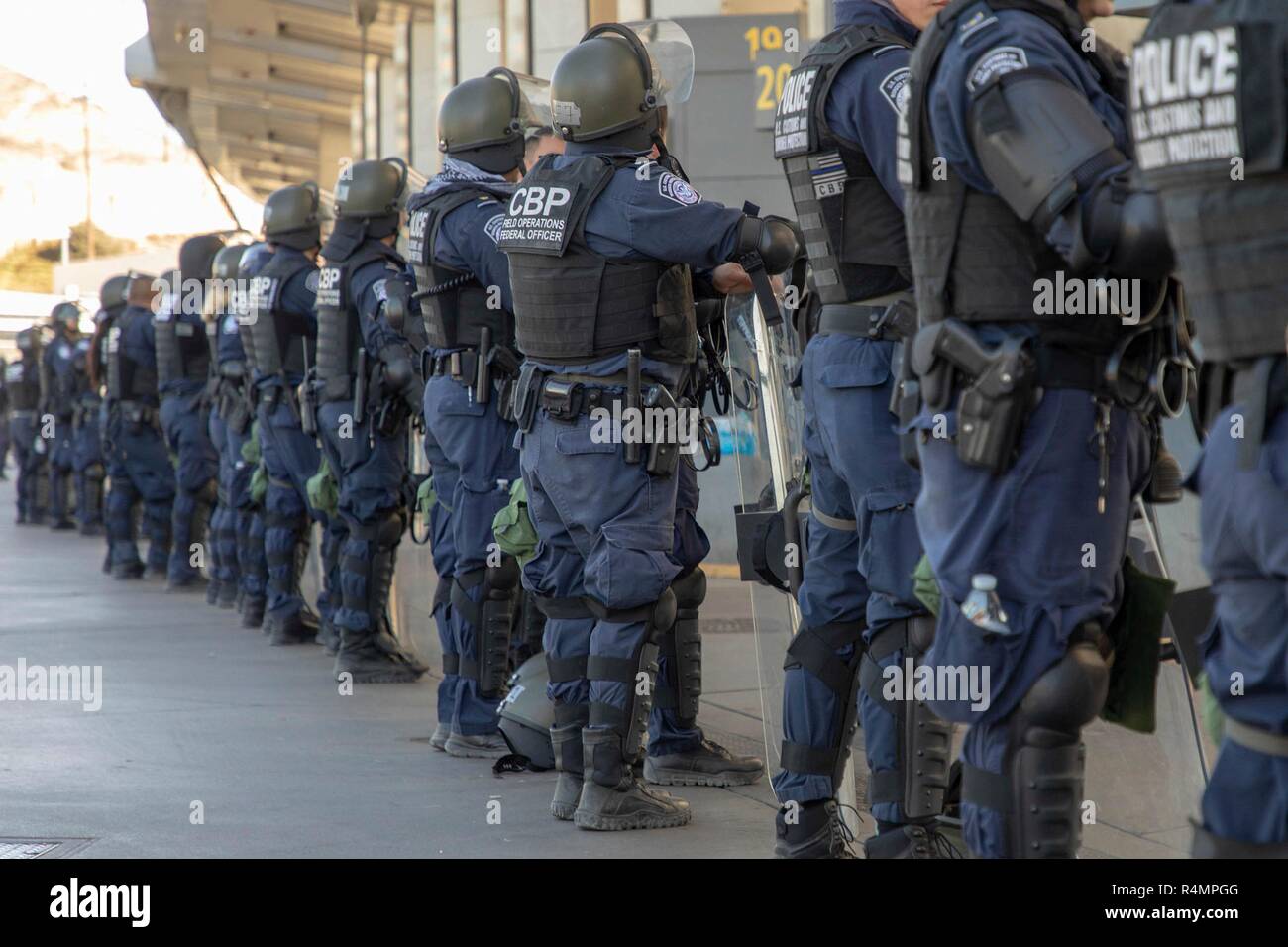 U.S. Customs and Border Patrol agents in riot gear shut the border into ...