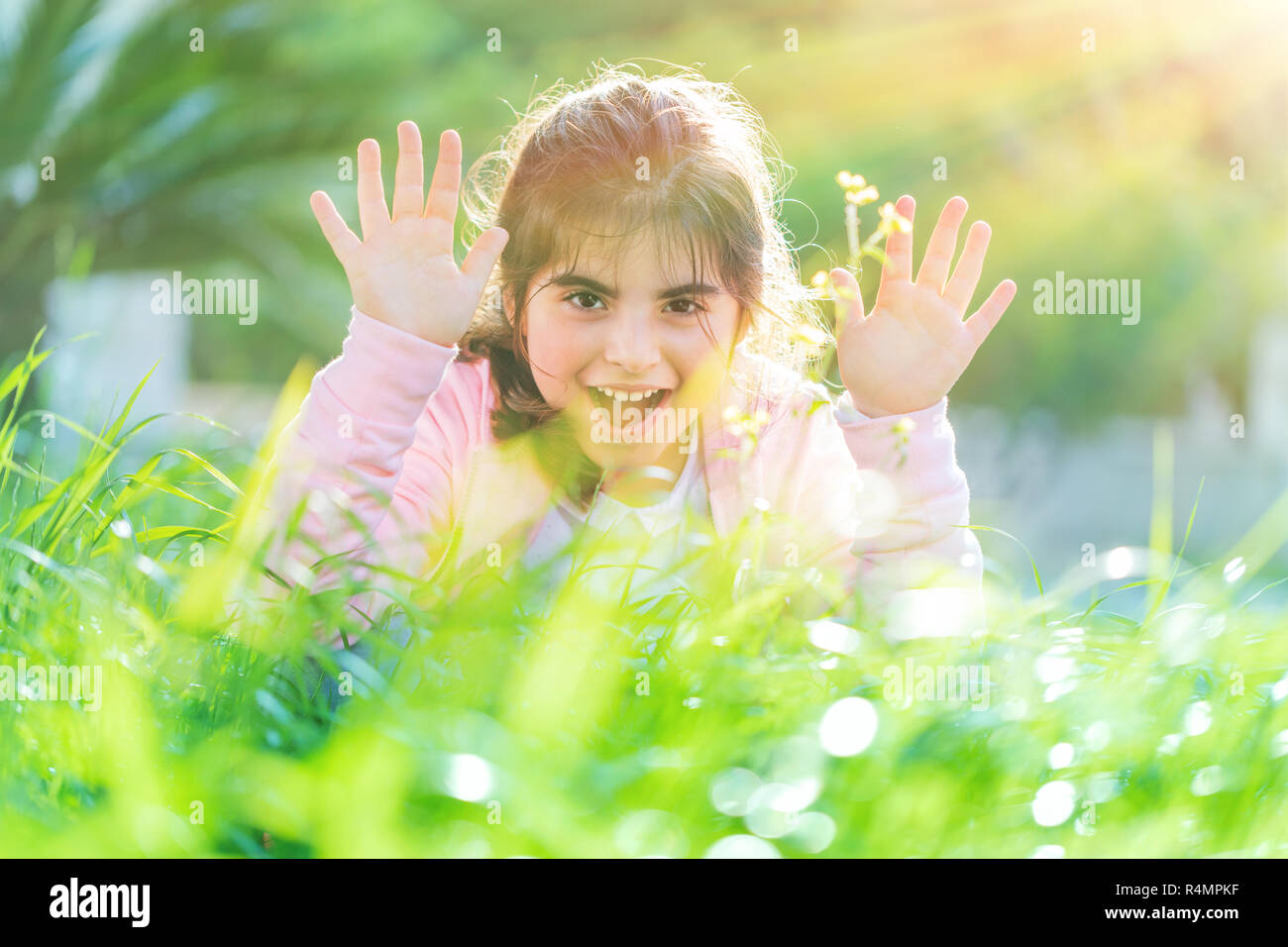 Pretty child playing outdoors Stock Photo - Alamy