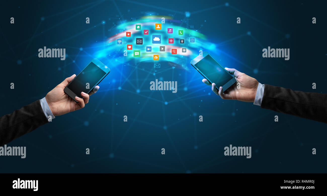 Two mobile phones syncing applications concept Stock Photo - Alamy