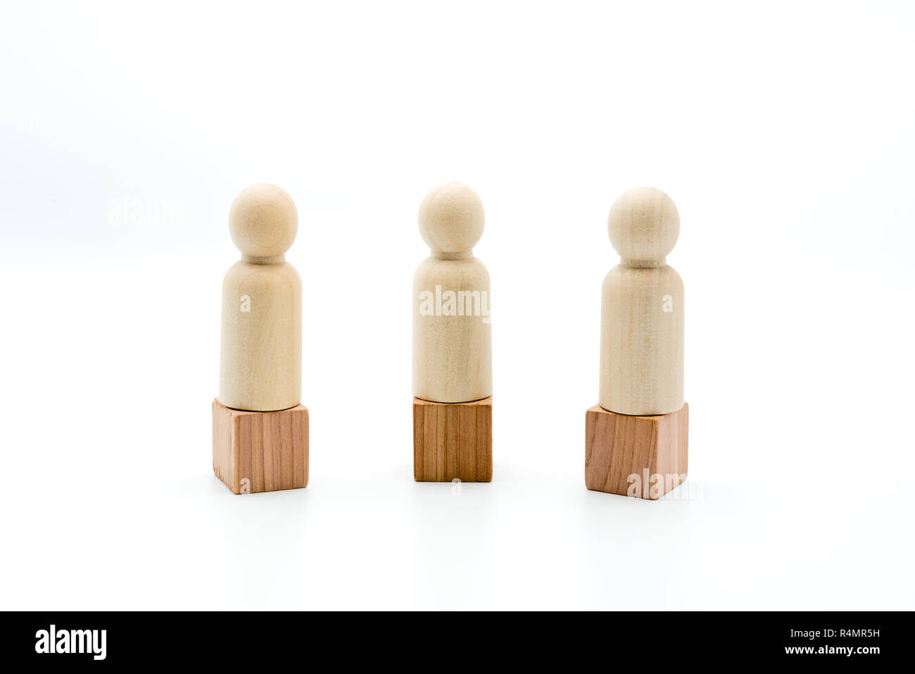 Wooden figures on cubes as business team concept, isolated on white ...