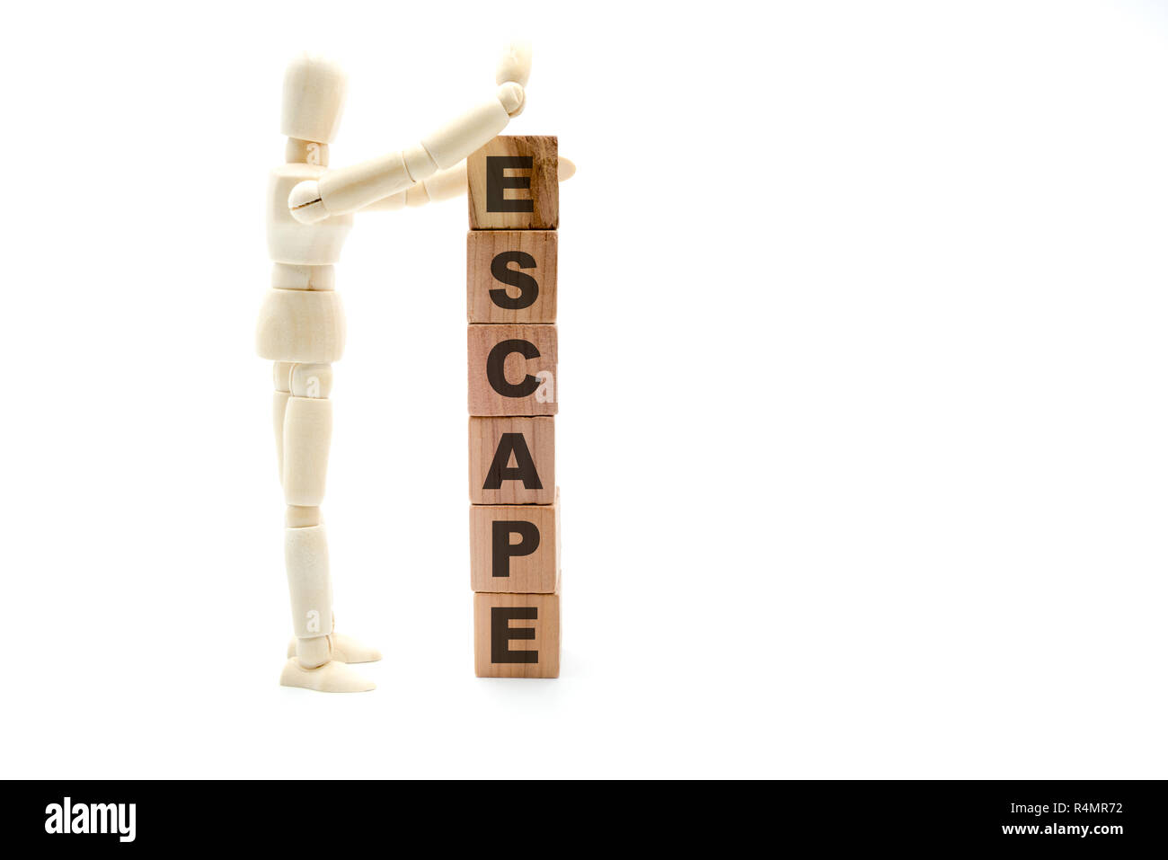 Wooden figure as businessman building Escape as tower of wood cubes ...