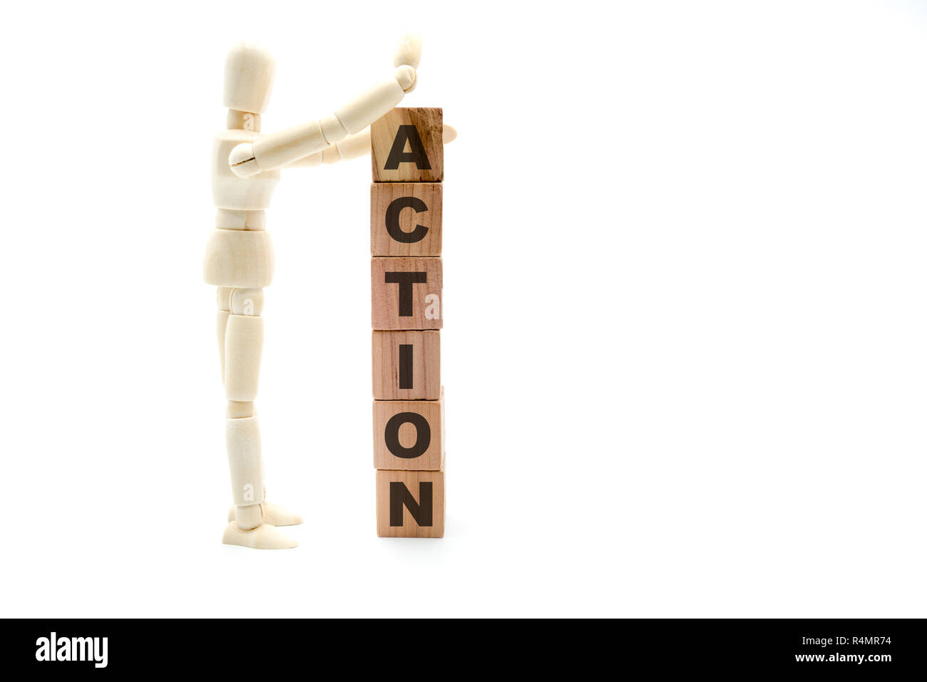 Wooden figure as businessman building Action as tower of wood cubes ...