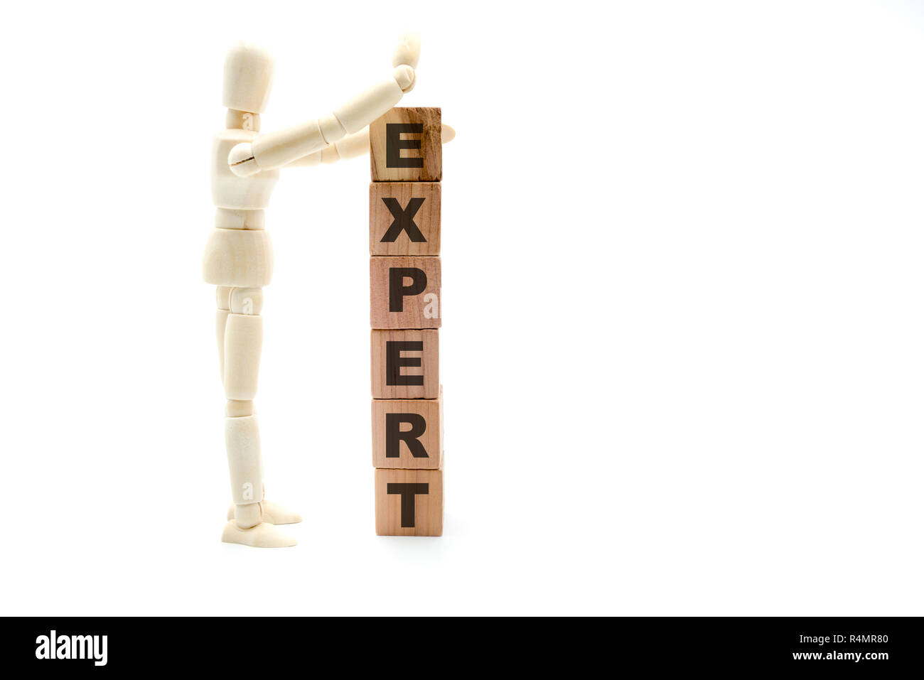 Wooden figure as businessman building Expert concept as tower of wood ...