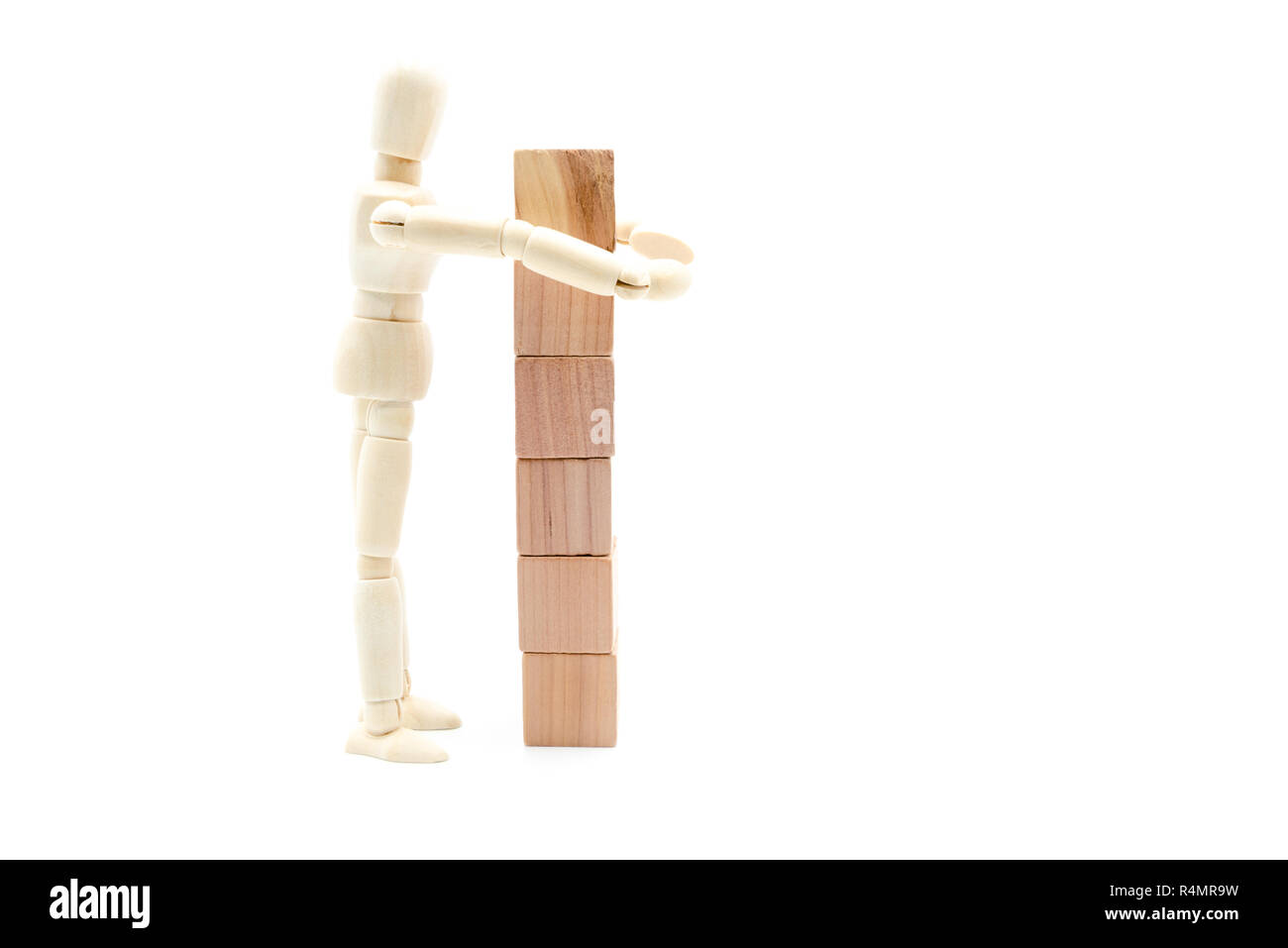 Wooden figure as businessman building tower of wood cubes, isolated on ...