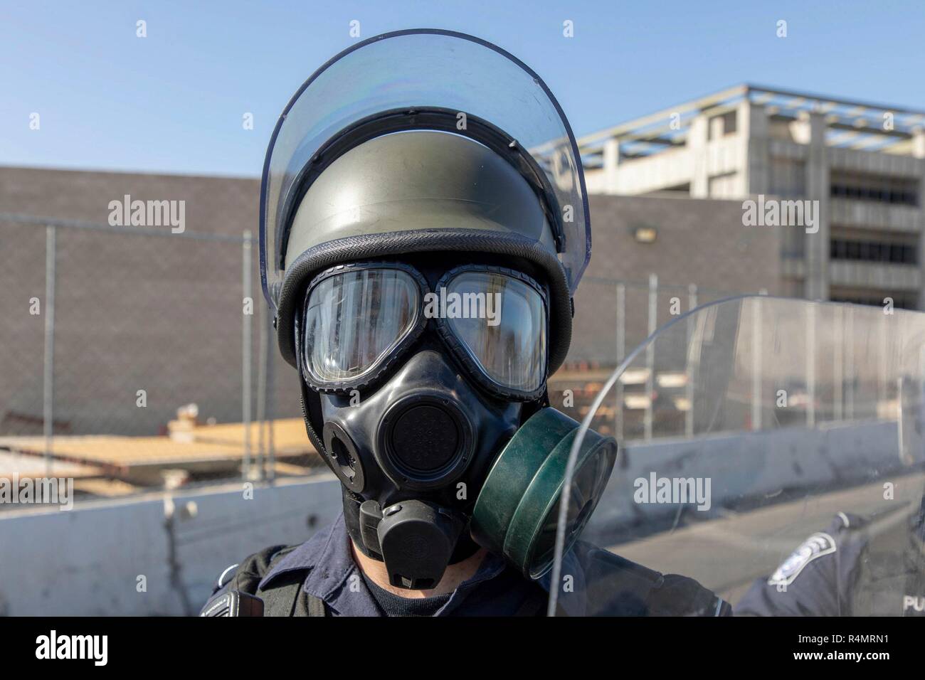 U.S. Customs and Border Patrol agents in riot gear shut the border into ...