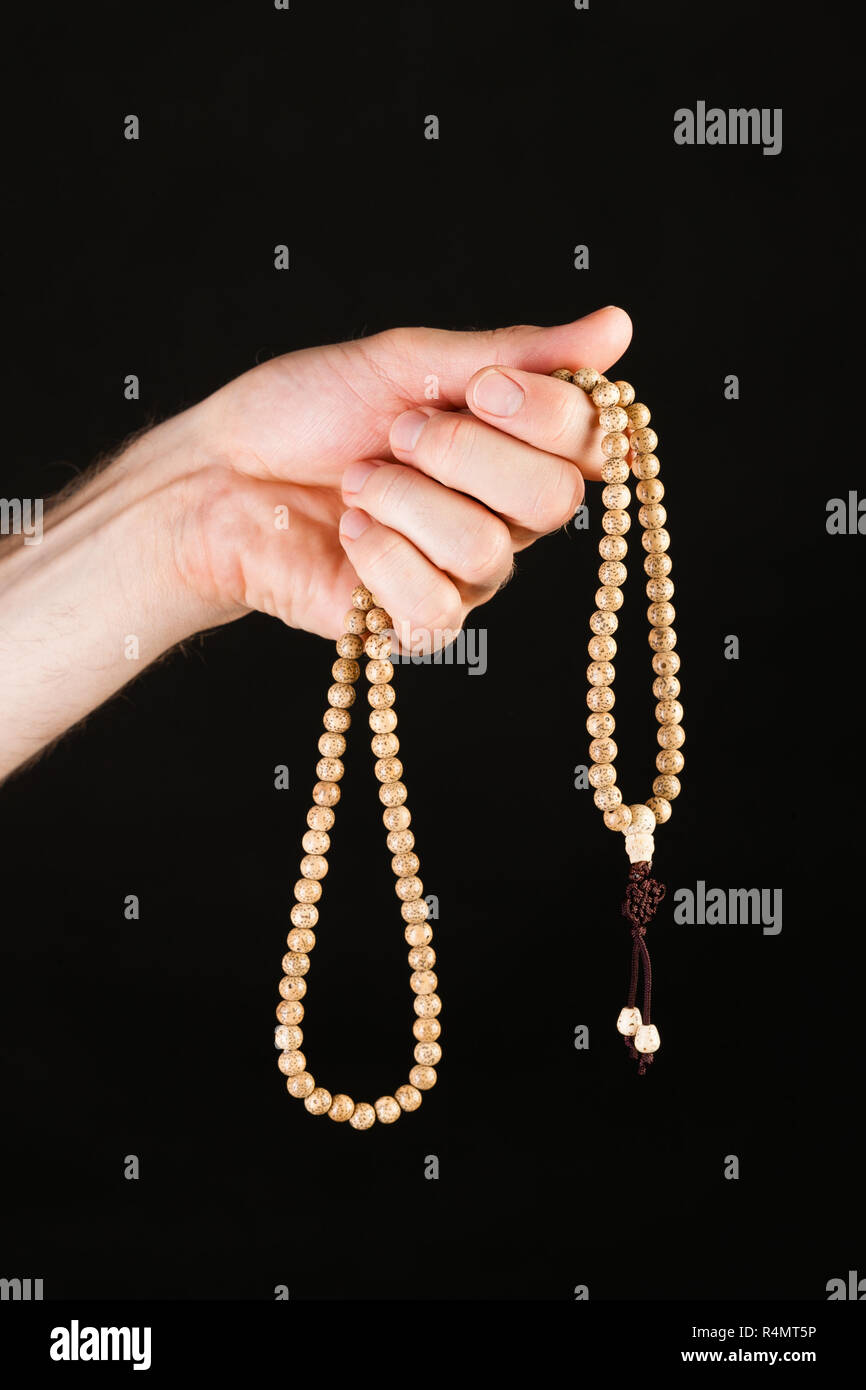 Hand praying with chain Stock Photo - Alamy