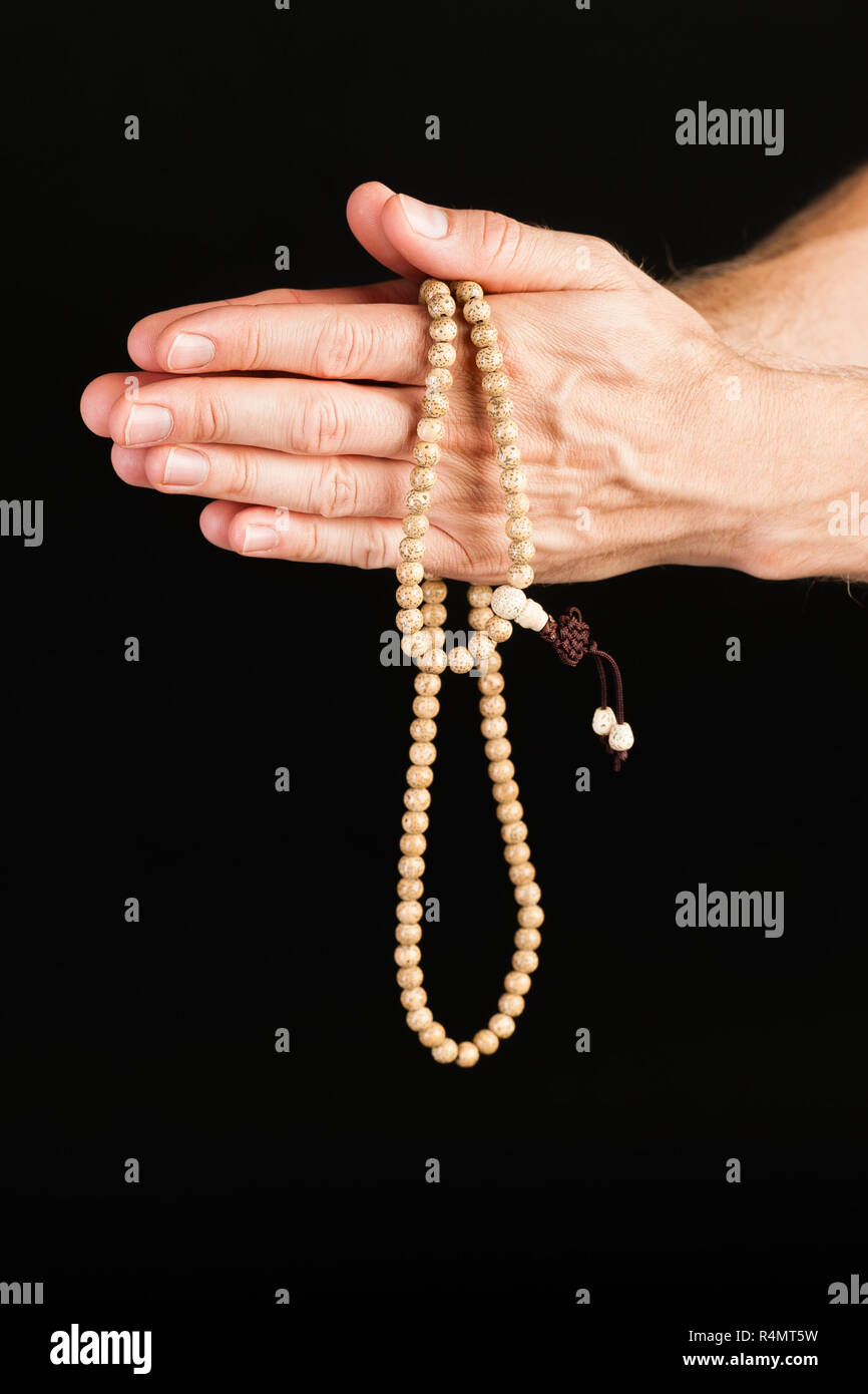 Hand praying with chain Stock Photo - Alamy