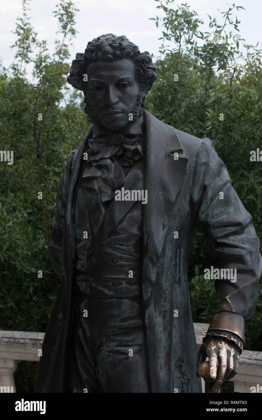 Pushkin monument with a shiny hand on the background of the forest ...