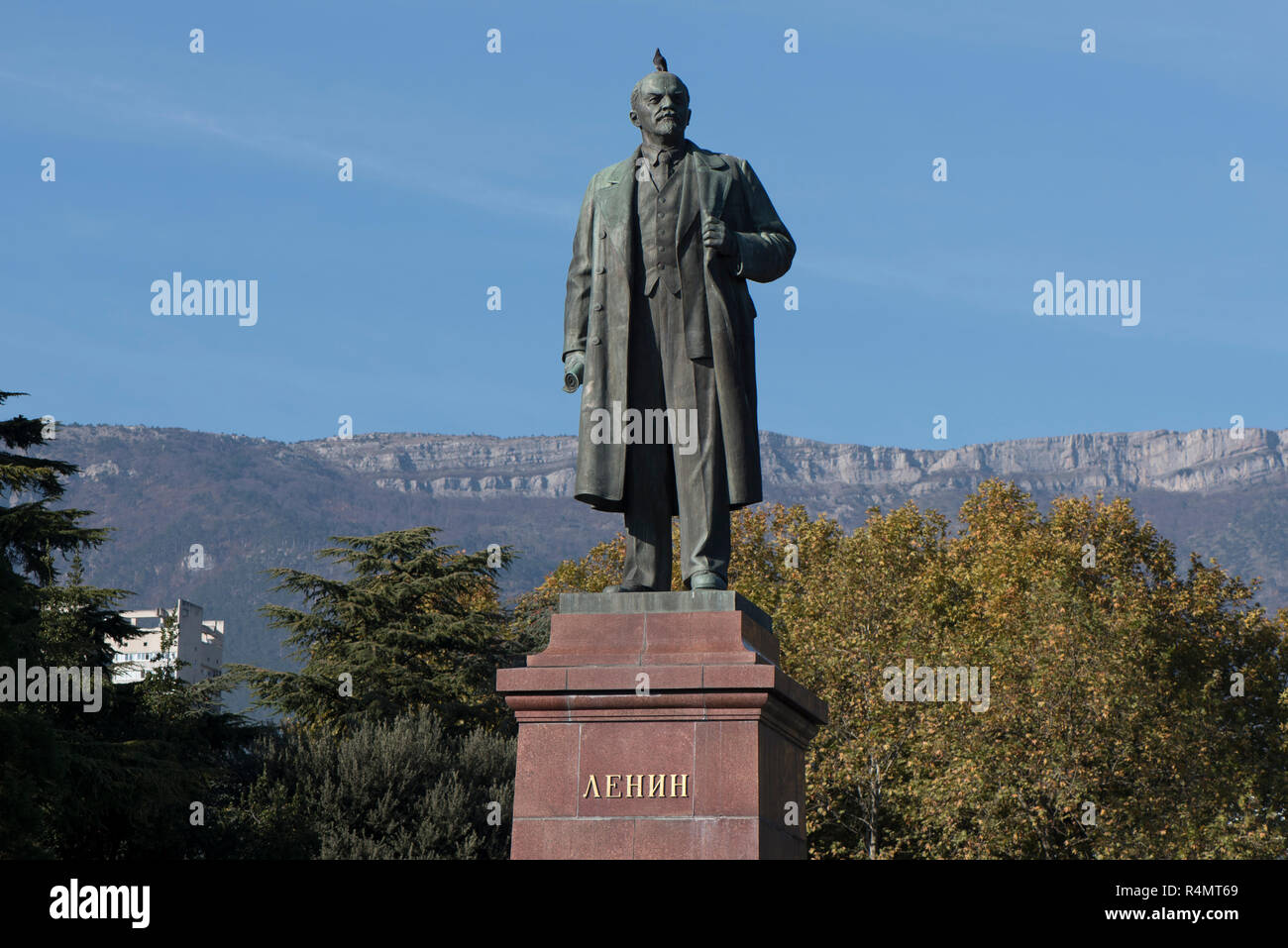 the monument to Lenin on a background of mountains, pine trees, forests ...