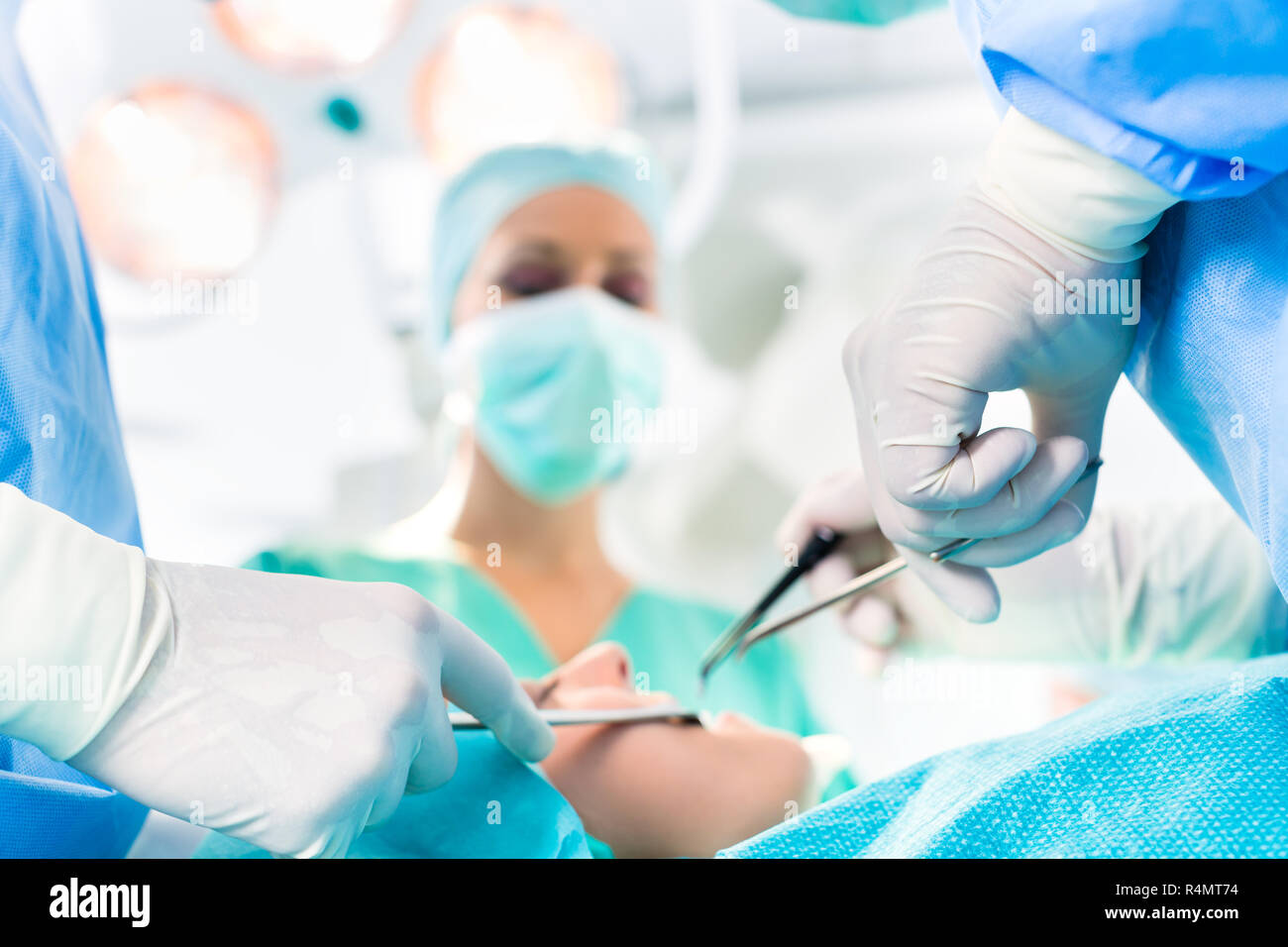 Surgeons operating in operation theater room Stock Photo - Alamy