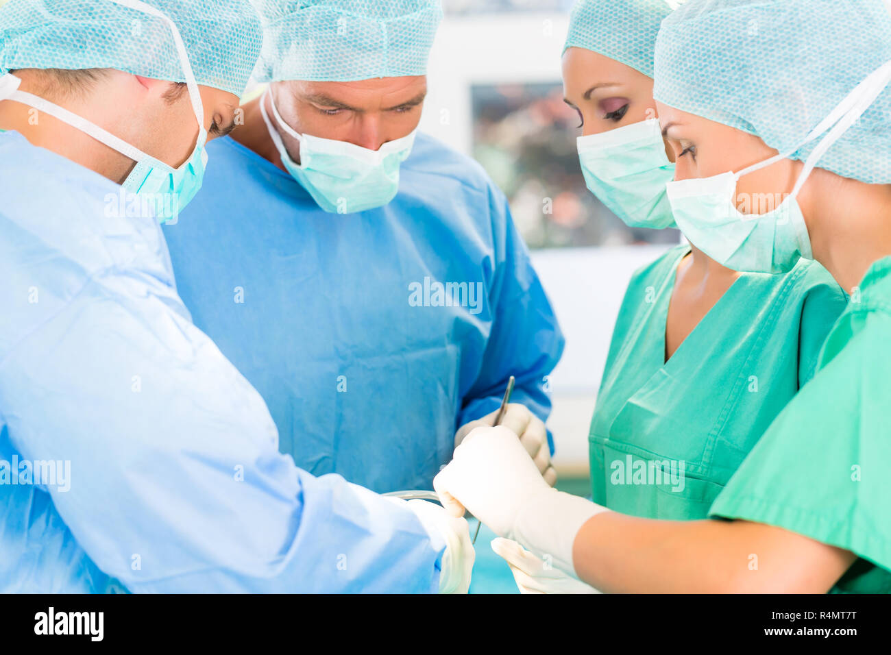 Surgeons operating patient in operation theater Stock Photo - Alamy