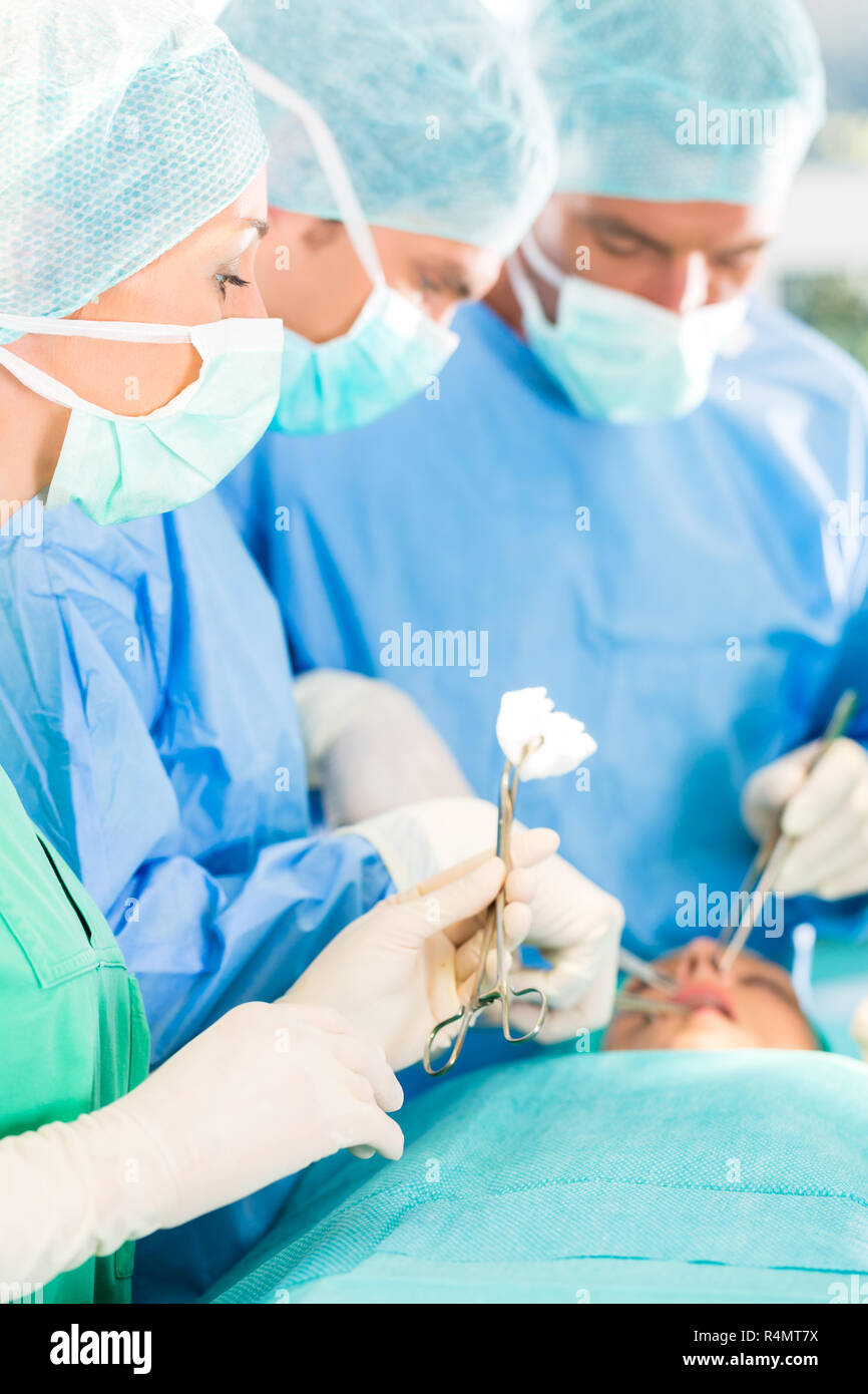 Surgeons operating patient in operation theater Stock Photo - Alamy