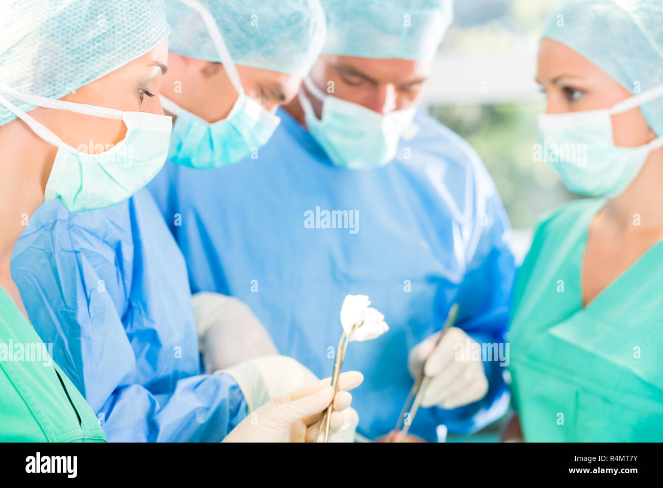 Surgeons operating patient in operation theater Stock Photo - Alamy