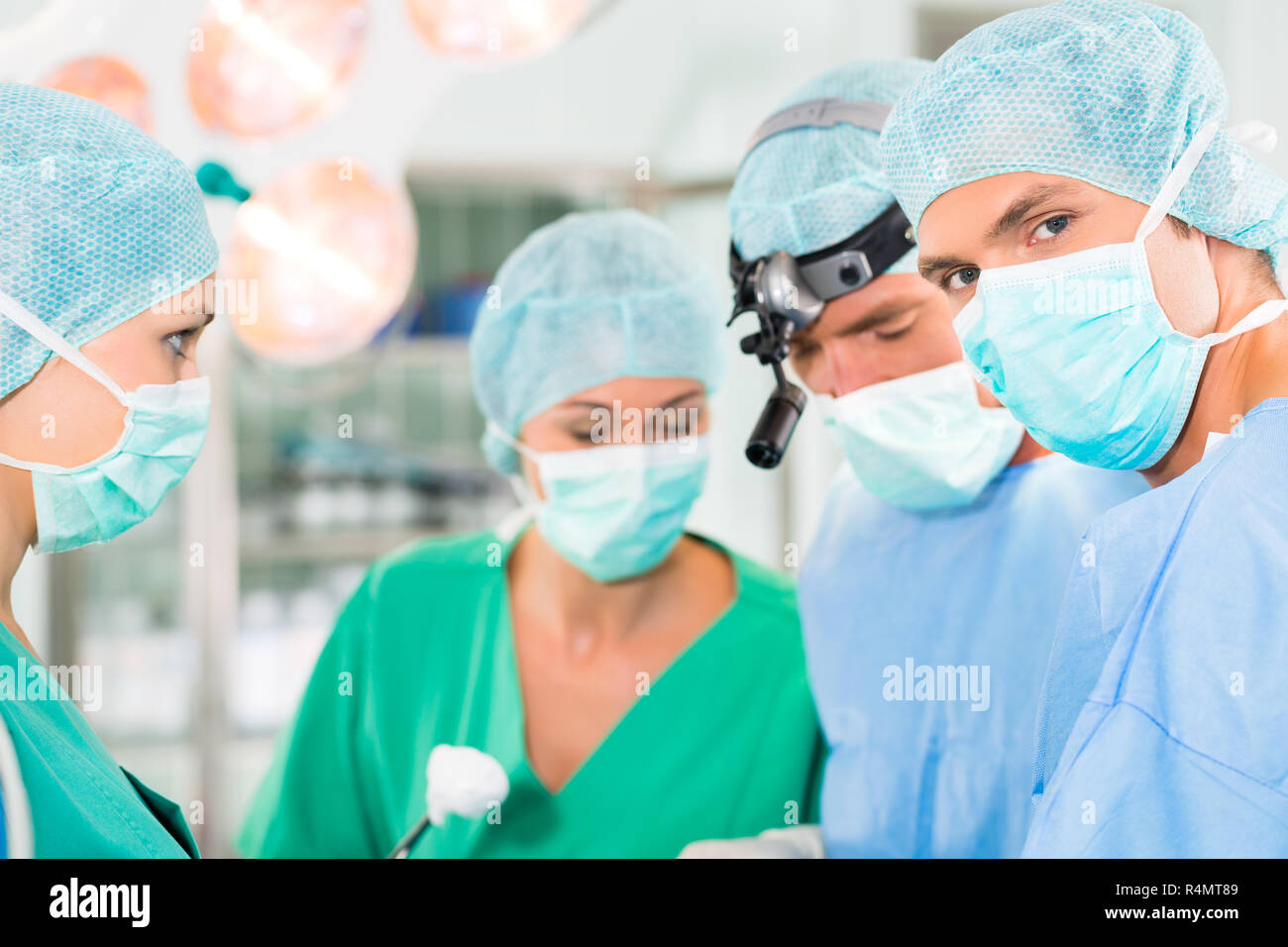 Surgeons operating in operation theater room Stock Photo - Alamy