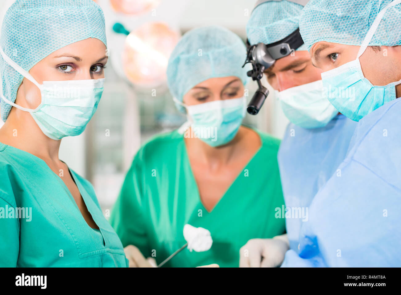 Surgeons operating in operation theater room Stock Photo - Alamy