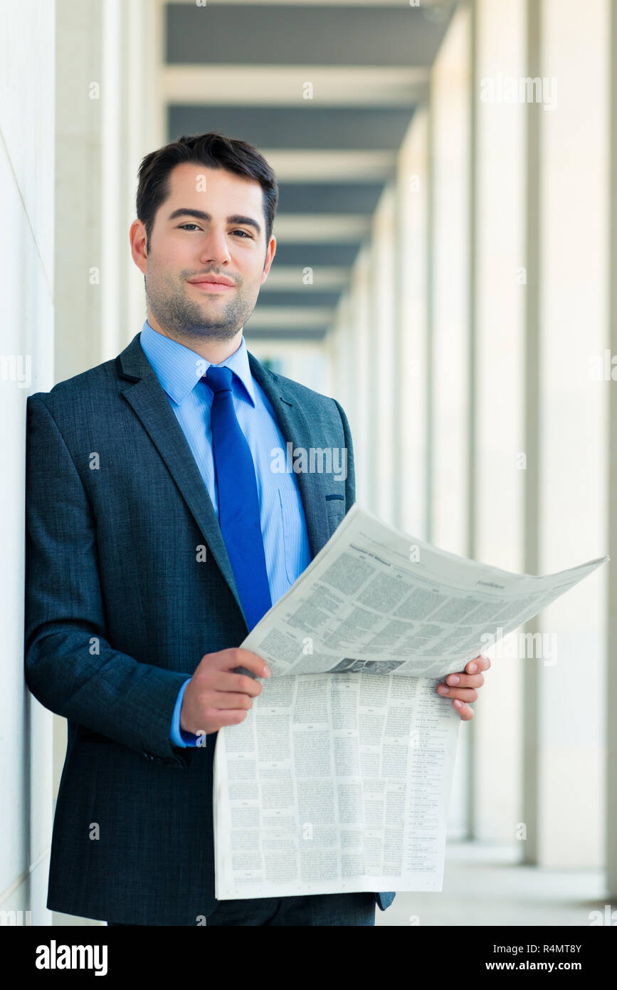 Young man walking reading newspaper hi-res stock photography and images ...